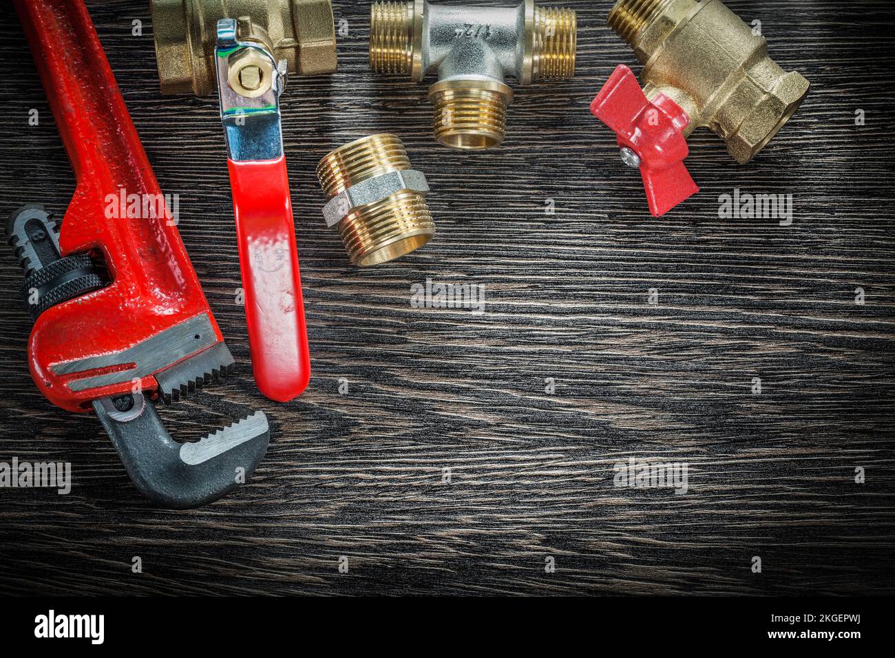 Plumbing monkey wrench pipe fittings water valve on vintage wooden ...