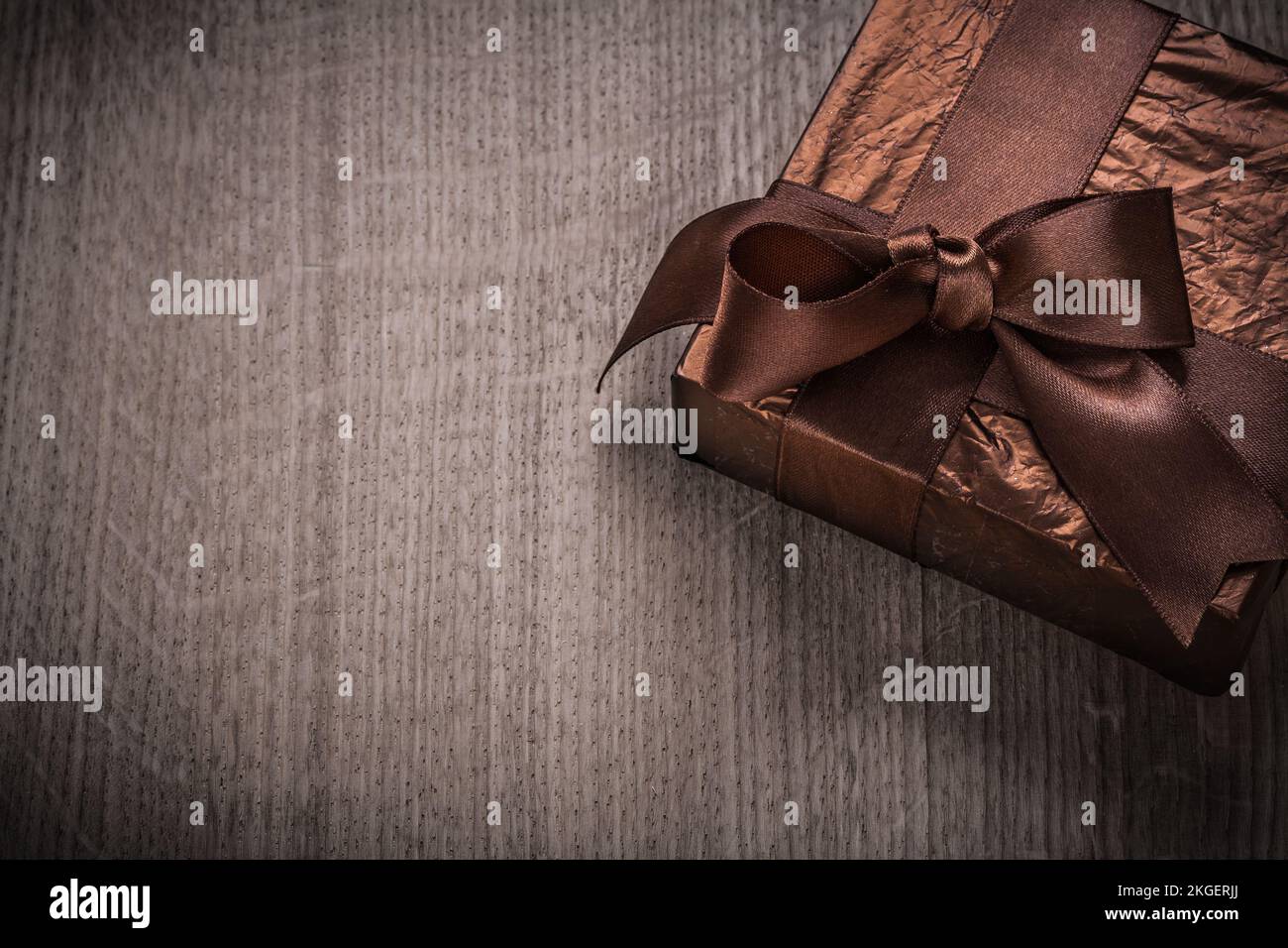 Present wrapped in glittery crumpled paper with bow celebration concept ...