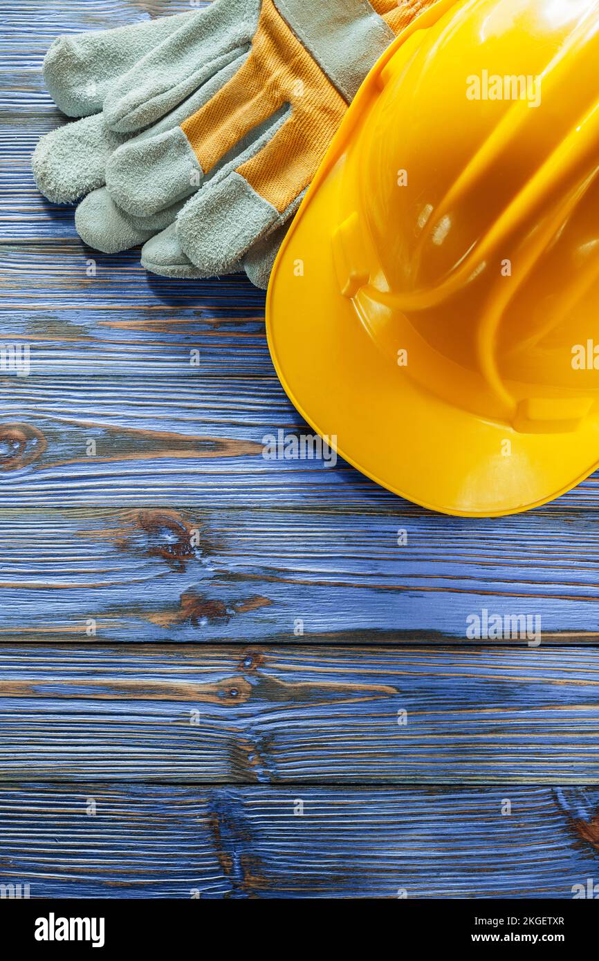 Protective gloves hard hat on vintage wooden board Stock Photo - Alamy