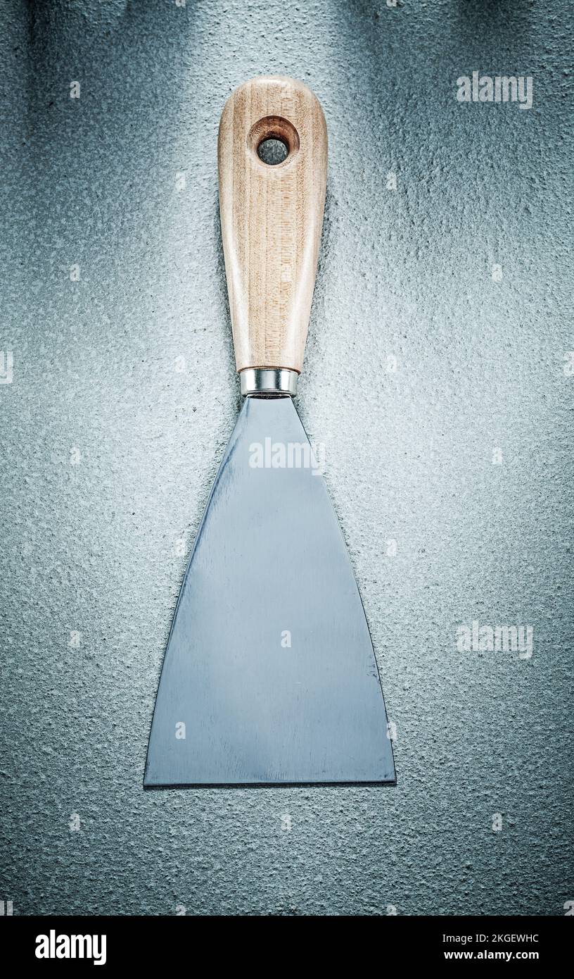 Putty knife on concrete background construction concept Stock Photo - Alamy