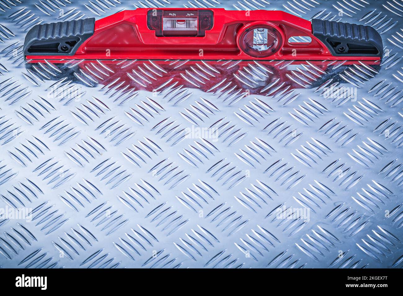 Red construction level on fluted metal plate maintenance concept Stock ...