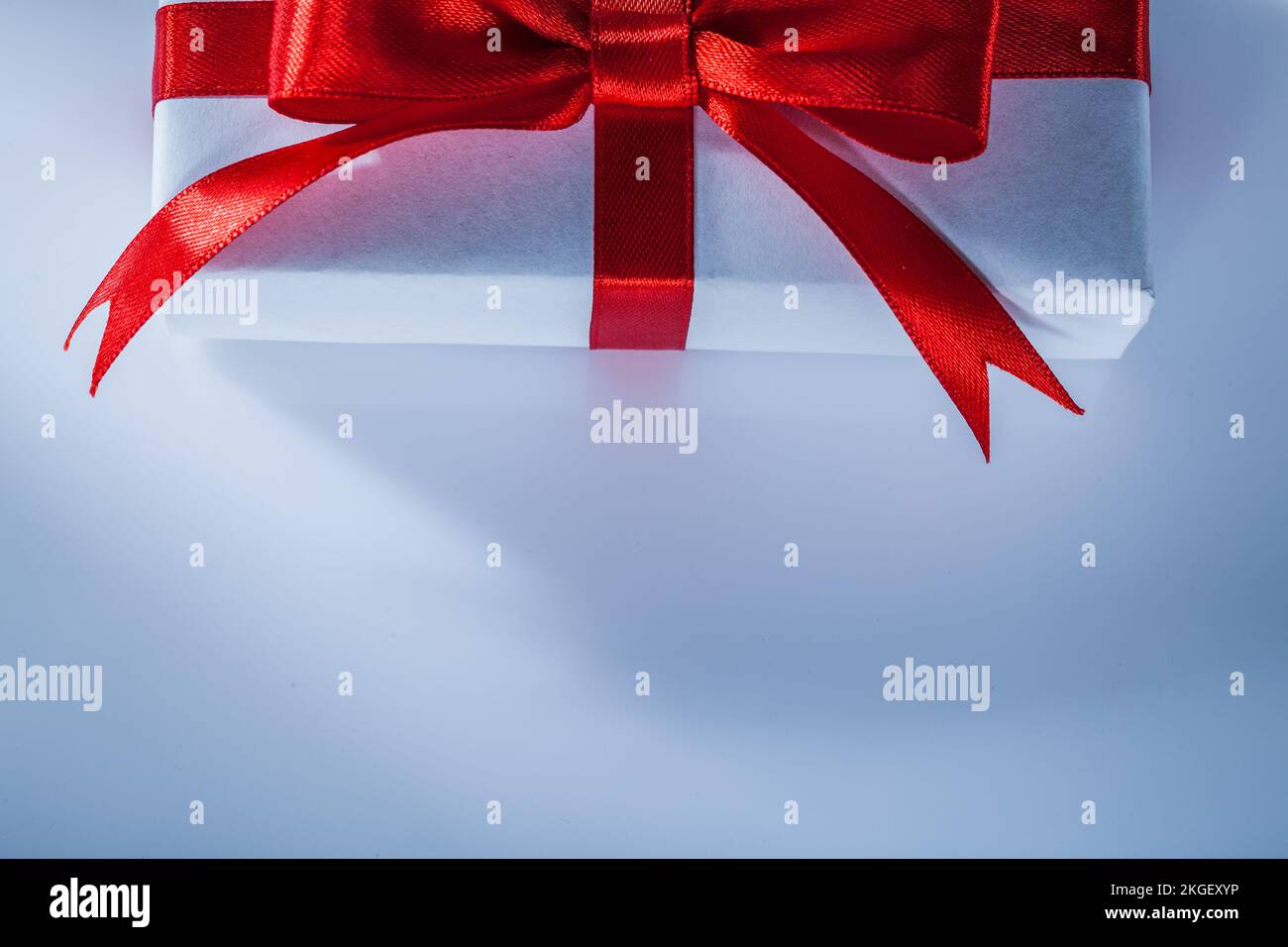 Red present box with knot on white background Stock Photo - Alamy
