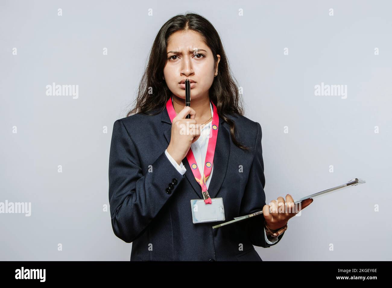 Confused Corporate Woman Contemplating a Decision – Pen to Lips ...
