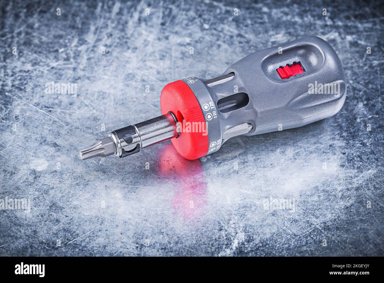 Reversible screwdriver on metallic background construction concept ...