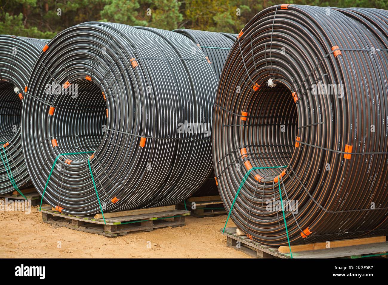 rolls of pipes on construction site in forest Stock Photo - Alamy