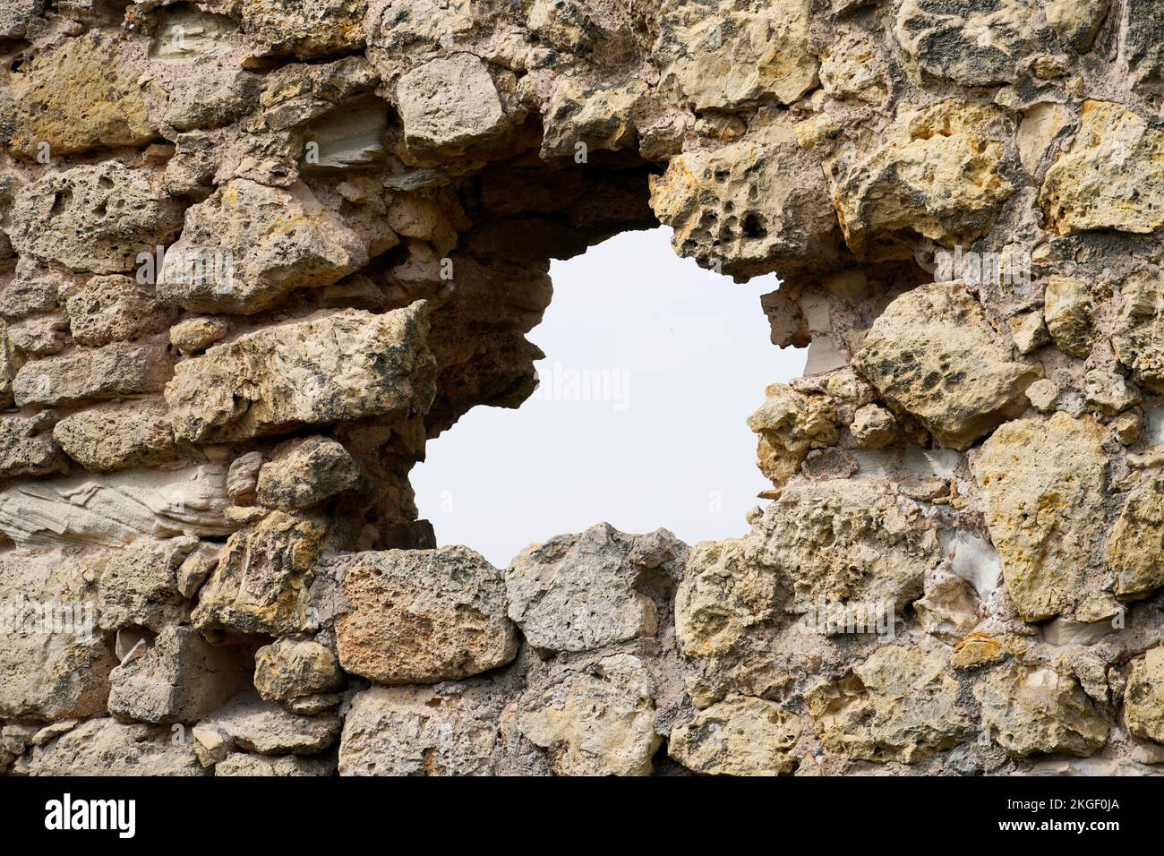 Old stone wall of a castle with a view of the sky. Defensive wall with ...