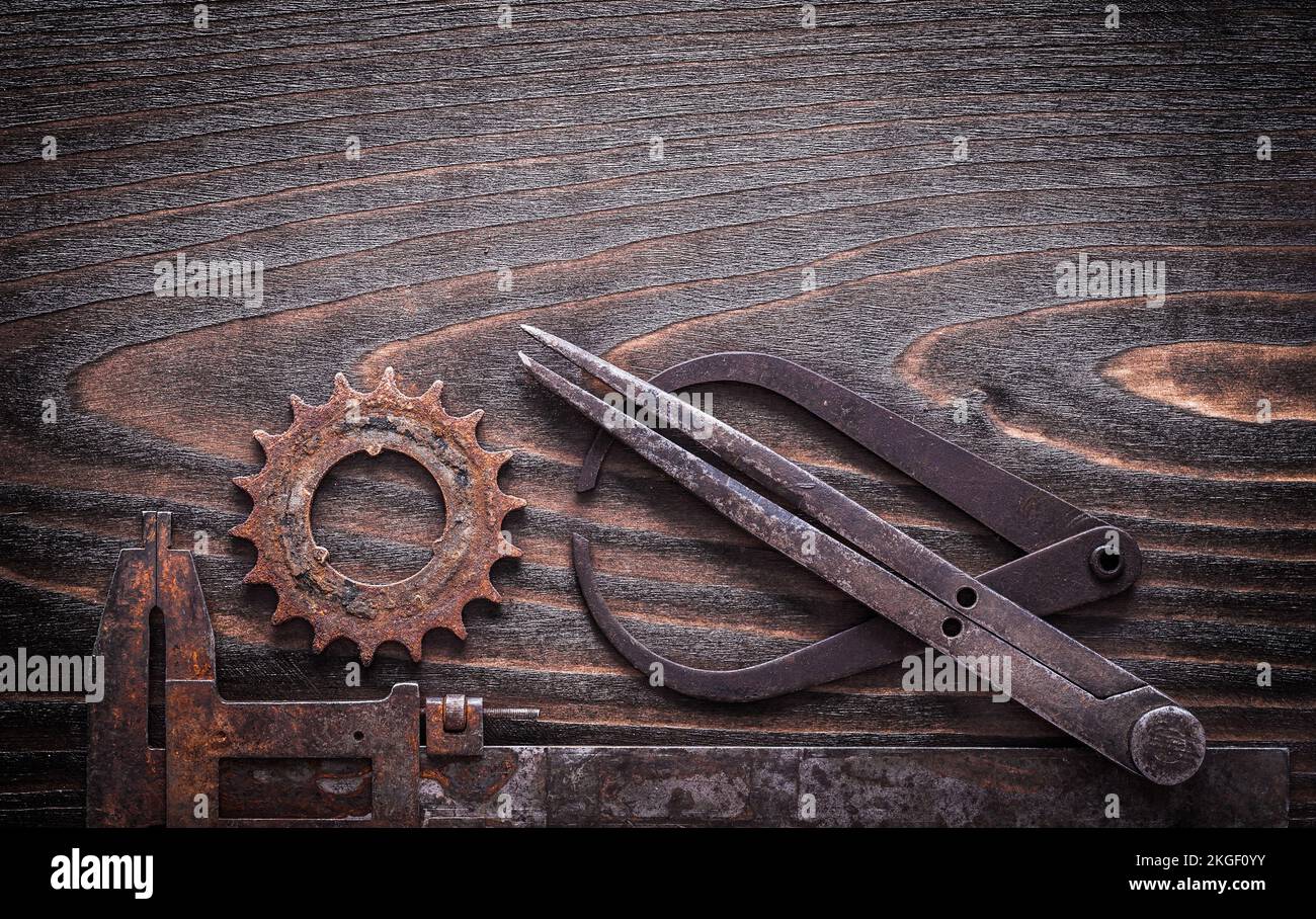 Rusted antique measuring calipers with gear wheel on vintage dark ...