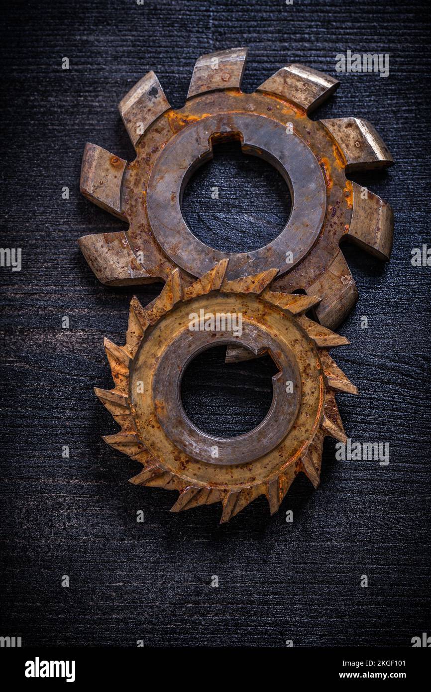 Rusty vintage milling cutters on wooden surface construction concept ...
