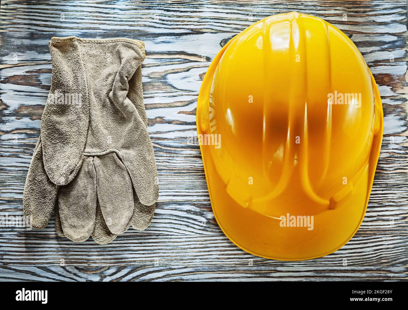 Safety gloves hard hat on vintage wooden board Stock Photo - Alamy