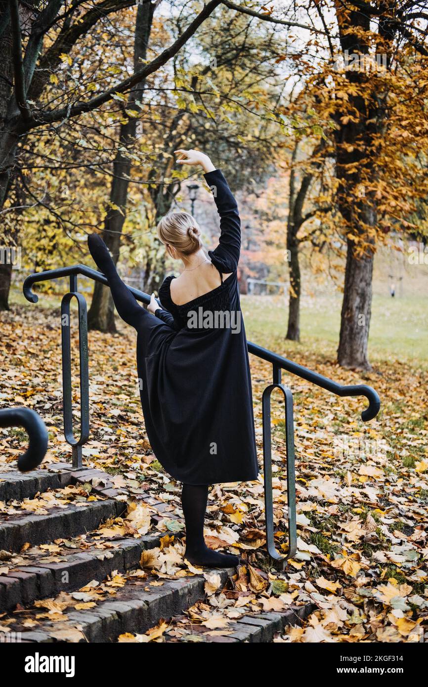 Ballerina Dancing in autumn city street, Modern Ballet Dancer in black ...