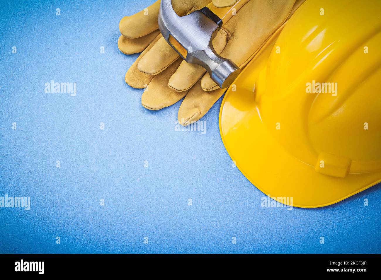 Set of claw hammer protective gloves building helmet on blue background ...
