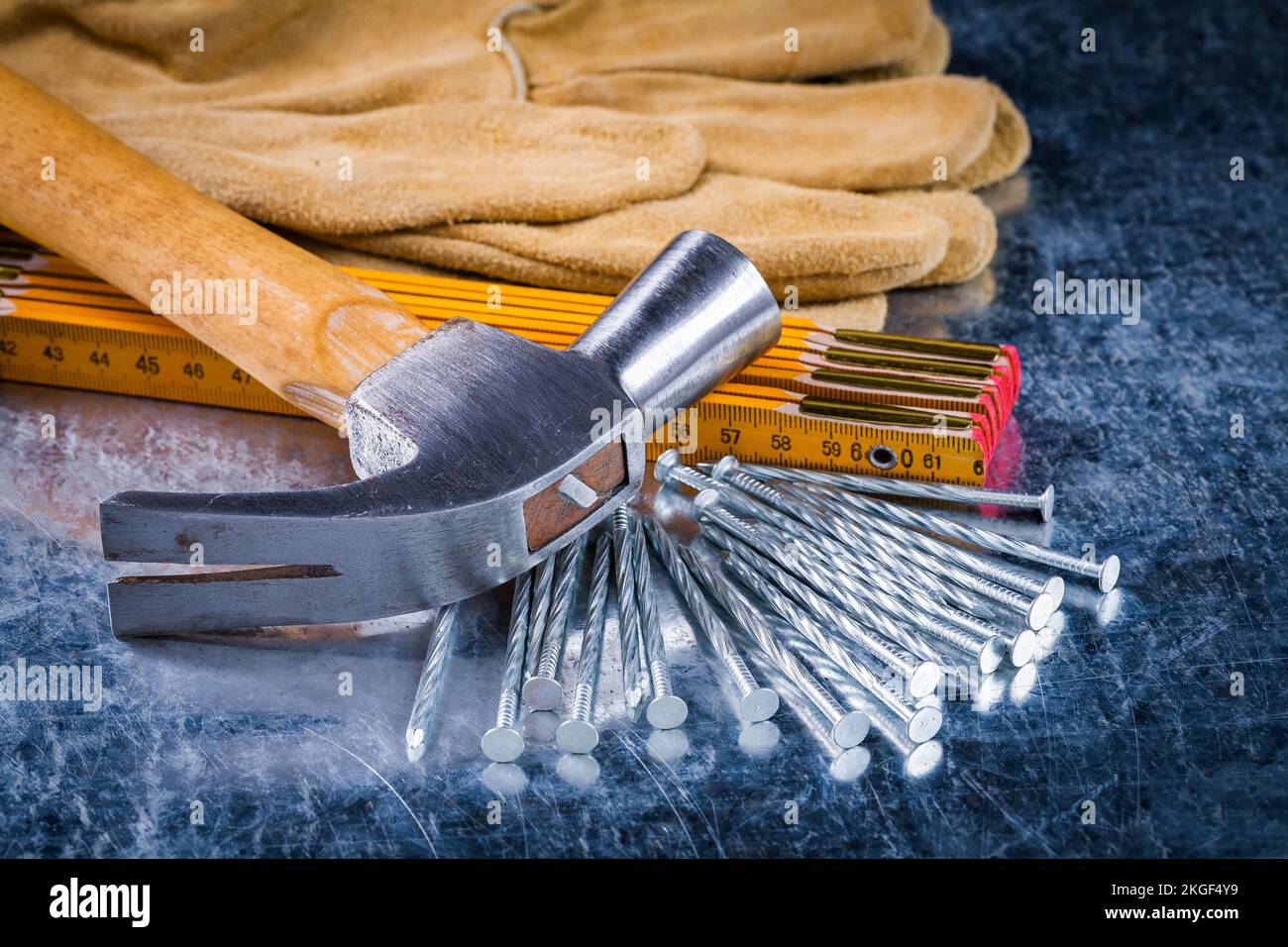 Set of leather construction gloves nails wooden measuring meter and ...