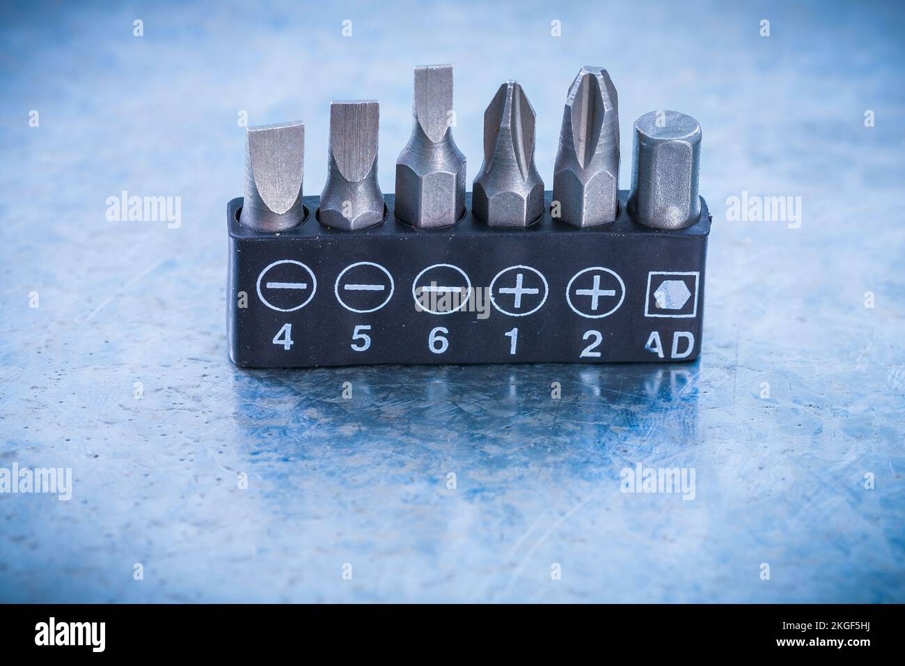 Set of stainless screwdriver bits on metallic background construction ...
