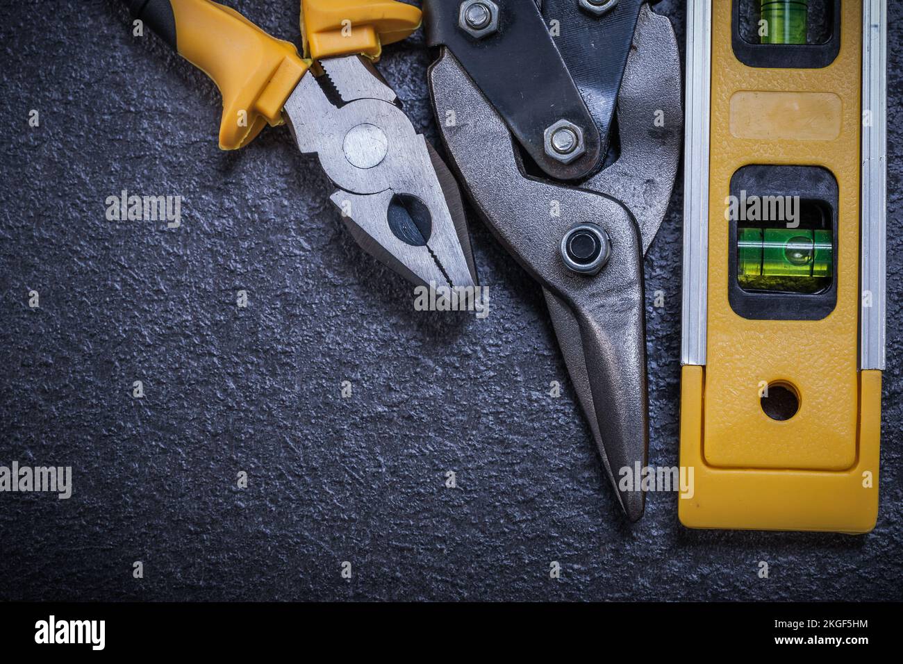 Set of tin snips pliers construction level on black background Stock ...