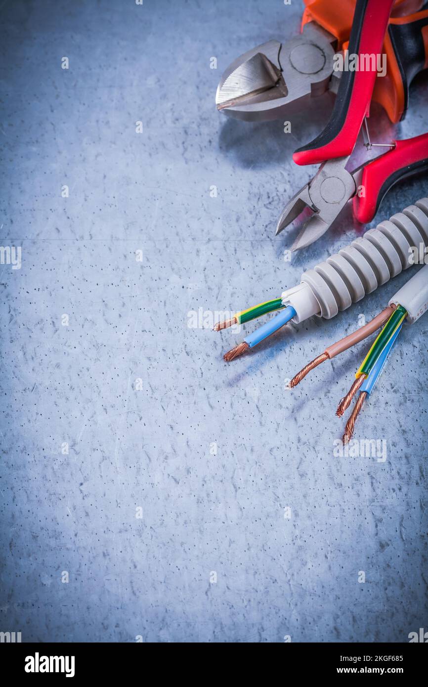 Sharp nippers corrugated pipe wire protection on metallic background ...