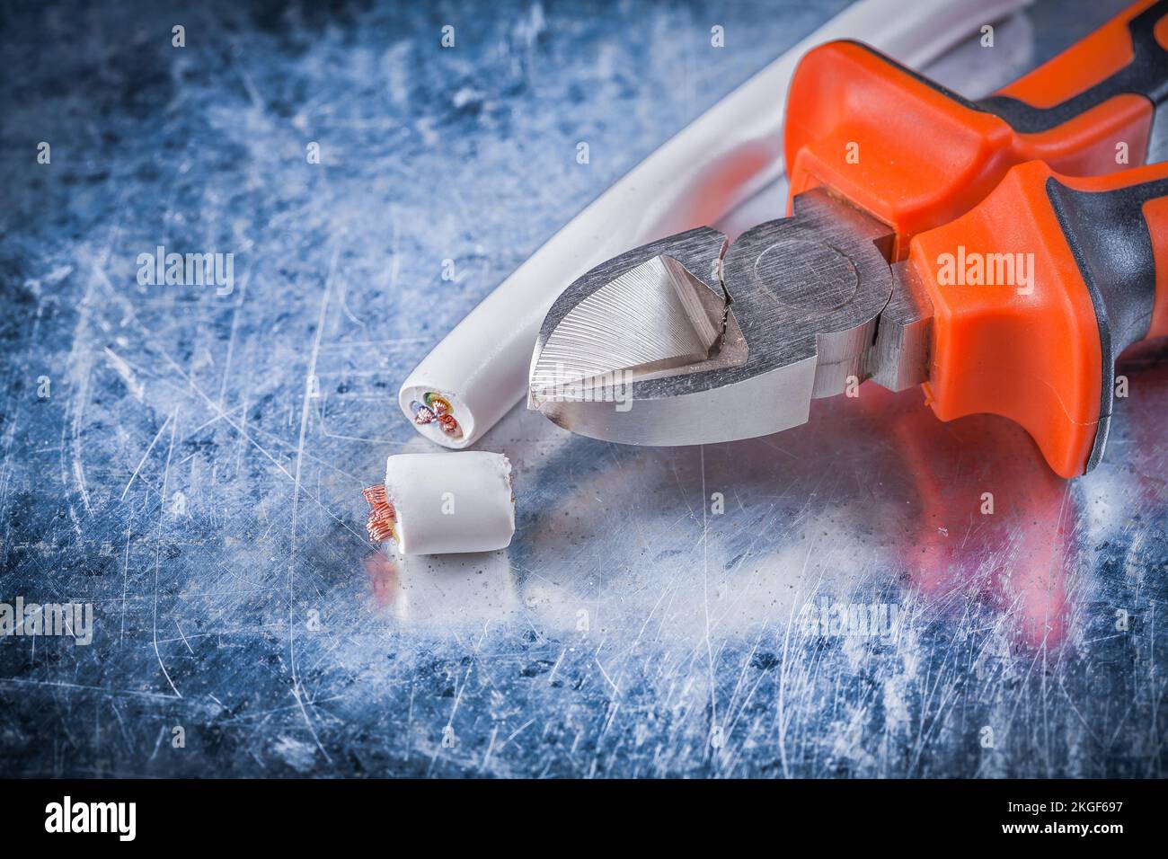 Sharp nippers electrical cable on scratched metallic background ...