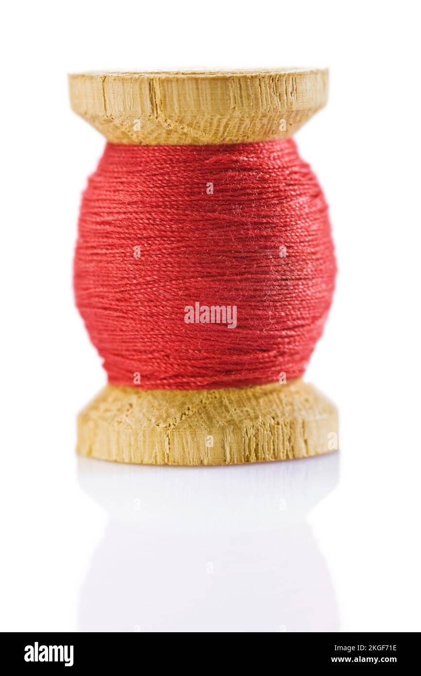 small sewing spool with red thread Stock Photo - Alamy