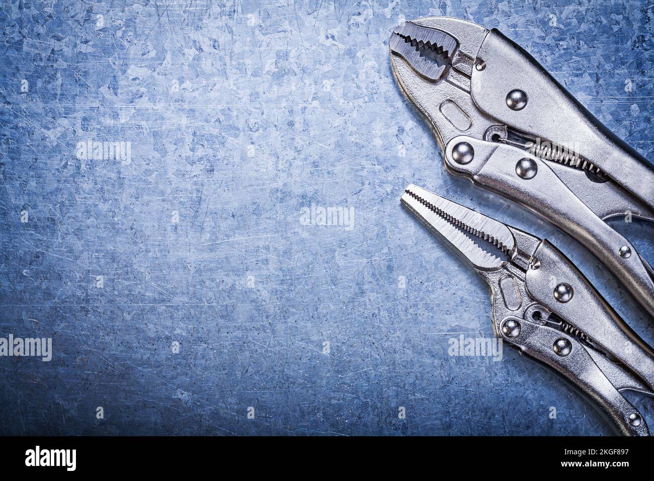 Stainless lock jaw pliers on metallic background construction concept ...