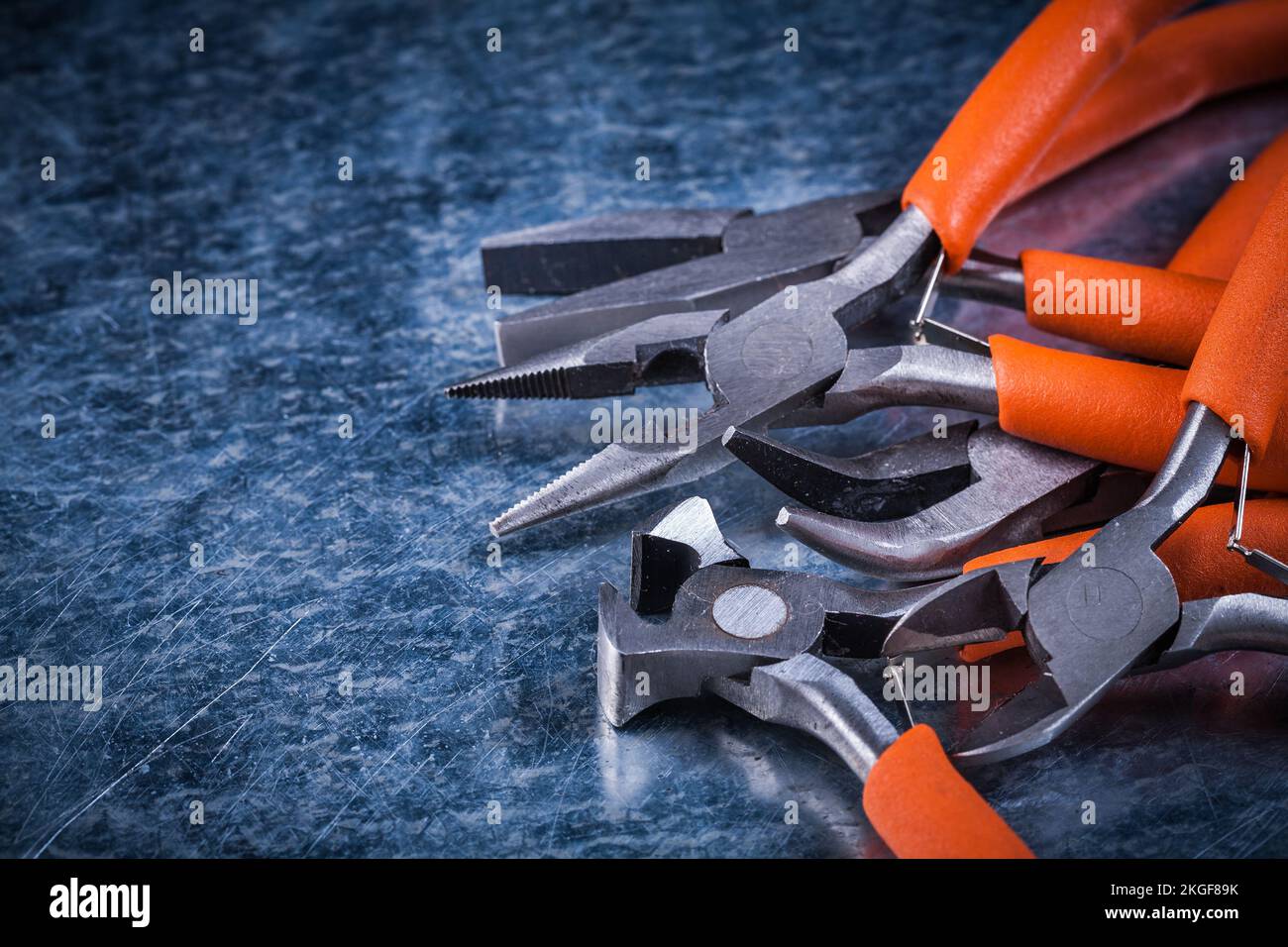 Stainless insulated electric pliers nippers on metallic background ...