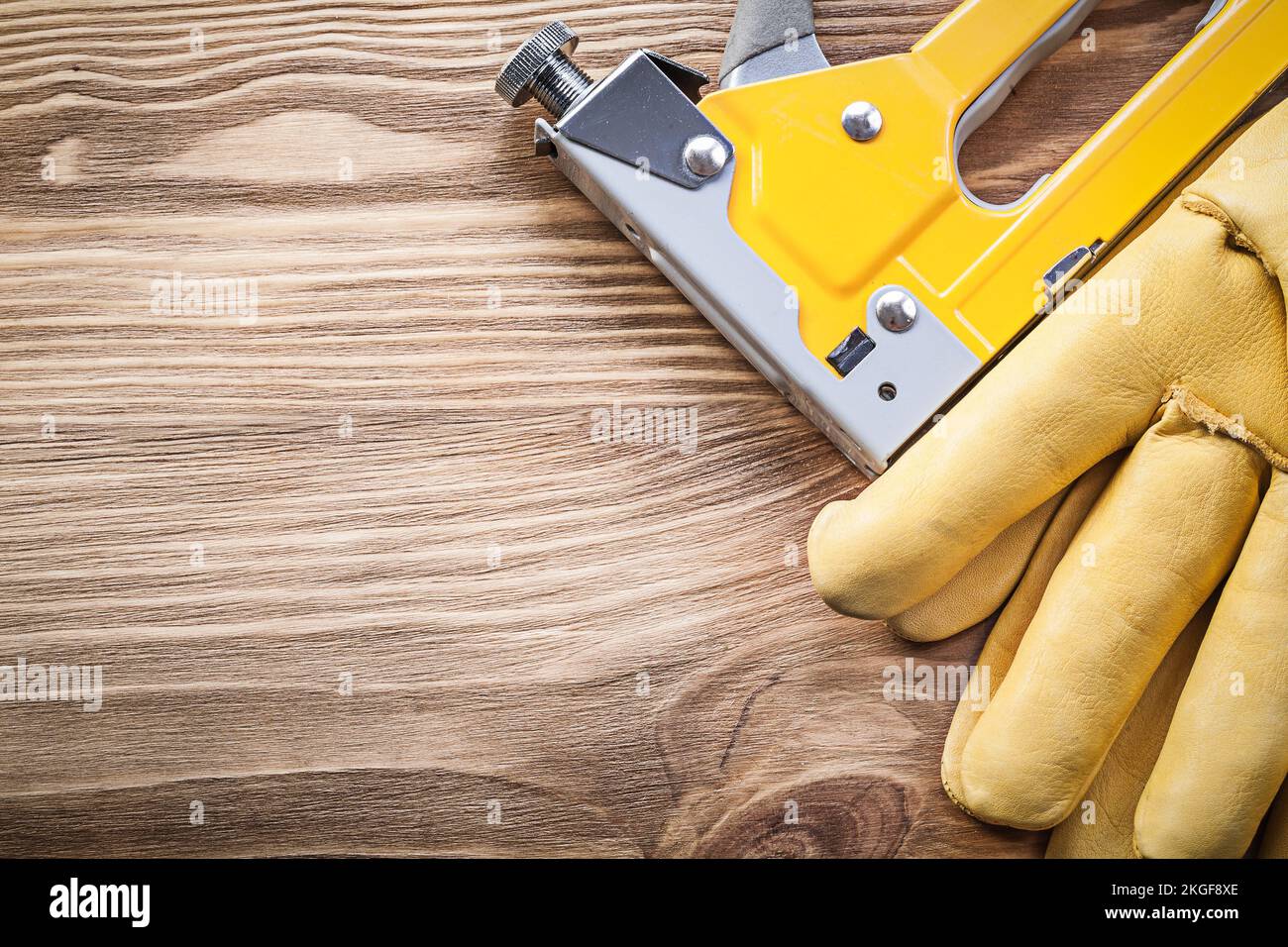 Stapler gun safety gloves on wood board construction concept Stock ...