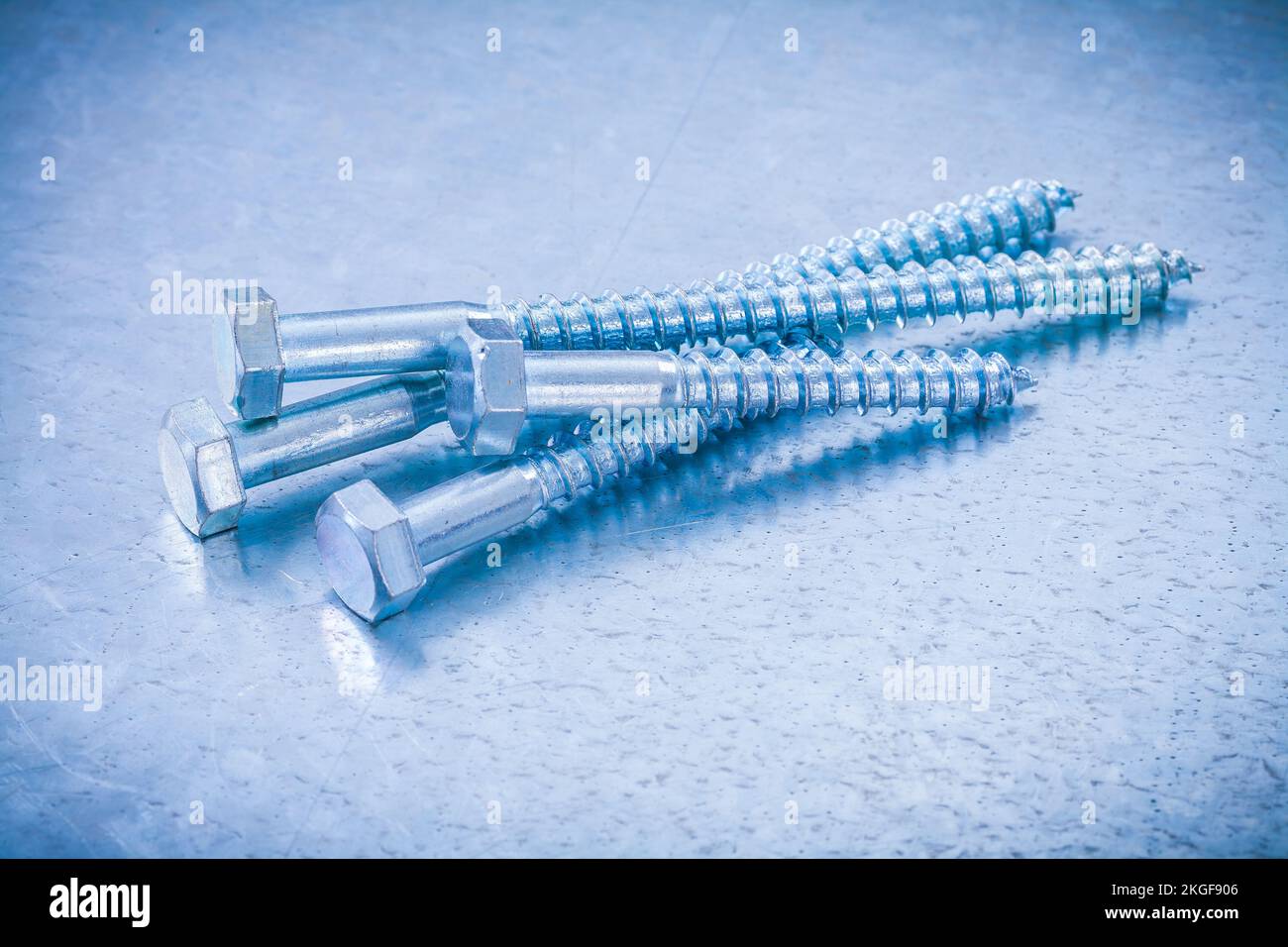Steel threaded bolts on metallic background construction concept Stock ...