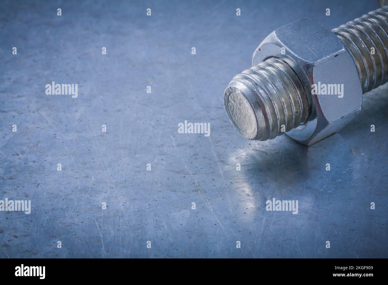 Steel threaded bolt and screw-nut on metallic background construction ...