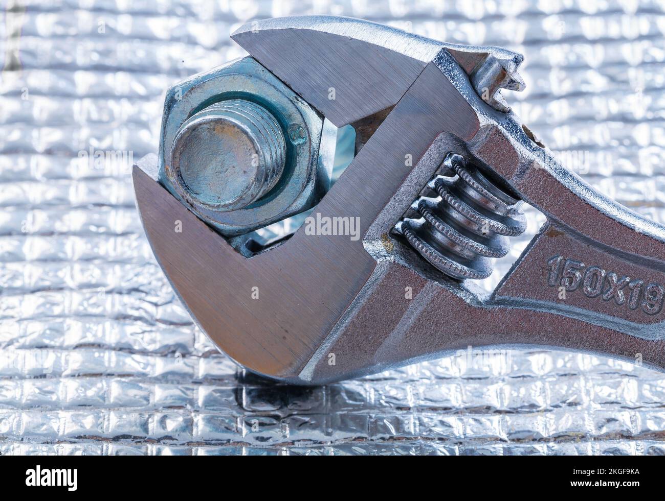 tainless adjustable spanner bolt and screw nut on metal background ...