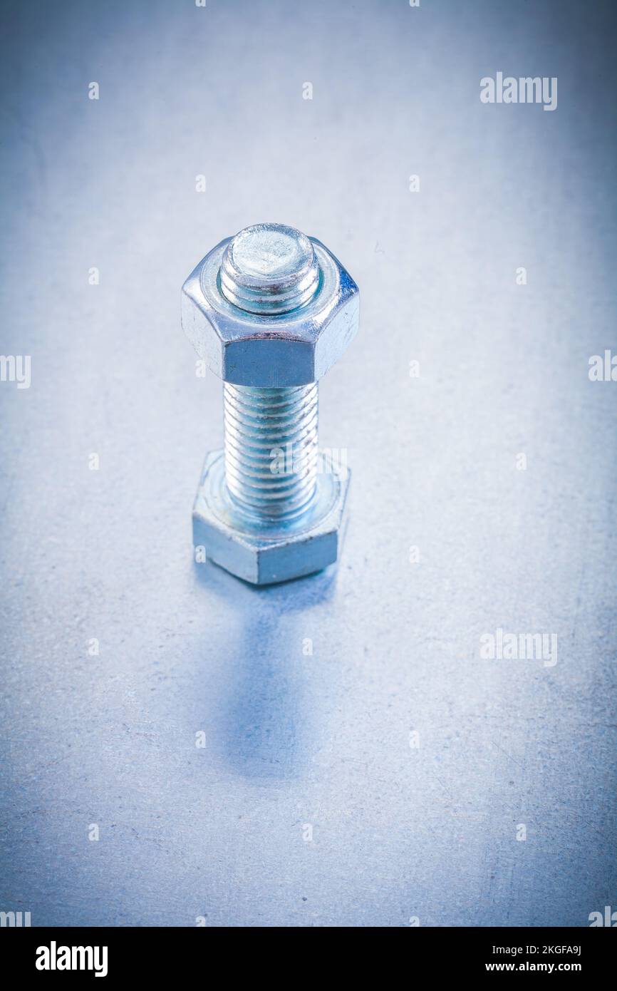 Threaded screw bolt with construction nut on metallic background ...