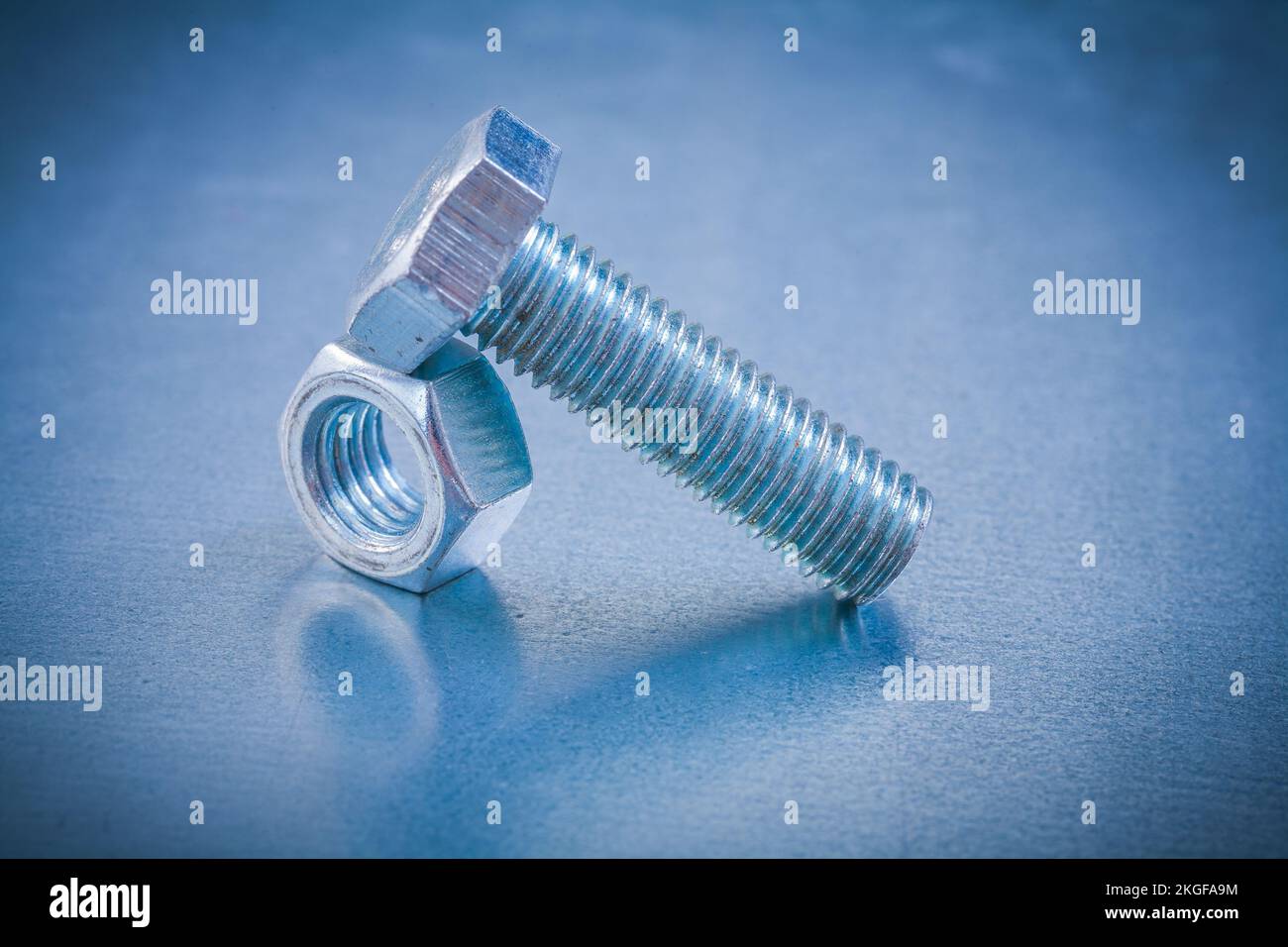 Threaded bolt and nut on metallic background construction concept Stock ...