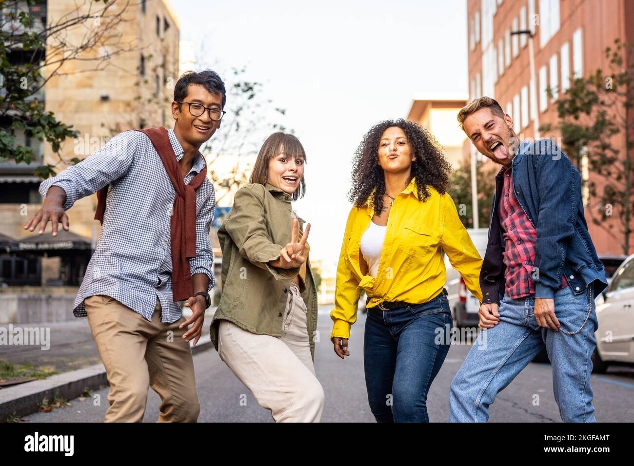 Multiracial group of friends having fun walking in a foolish way by ...