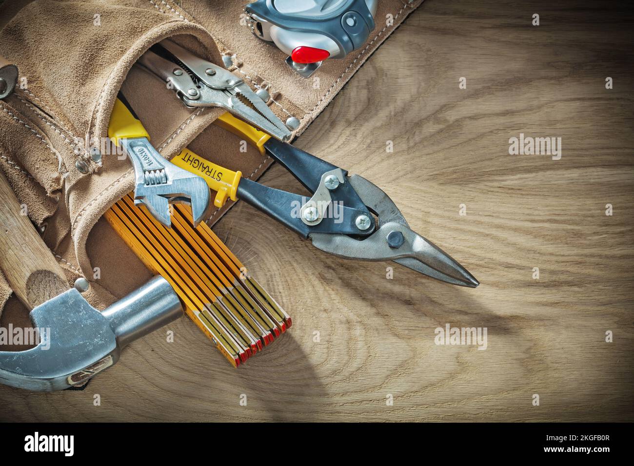 Tool belt with construction tooling on wooden board Stock Photo - Alamy