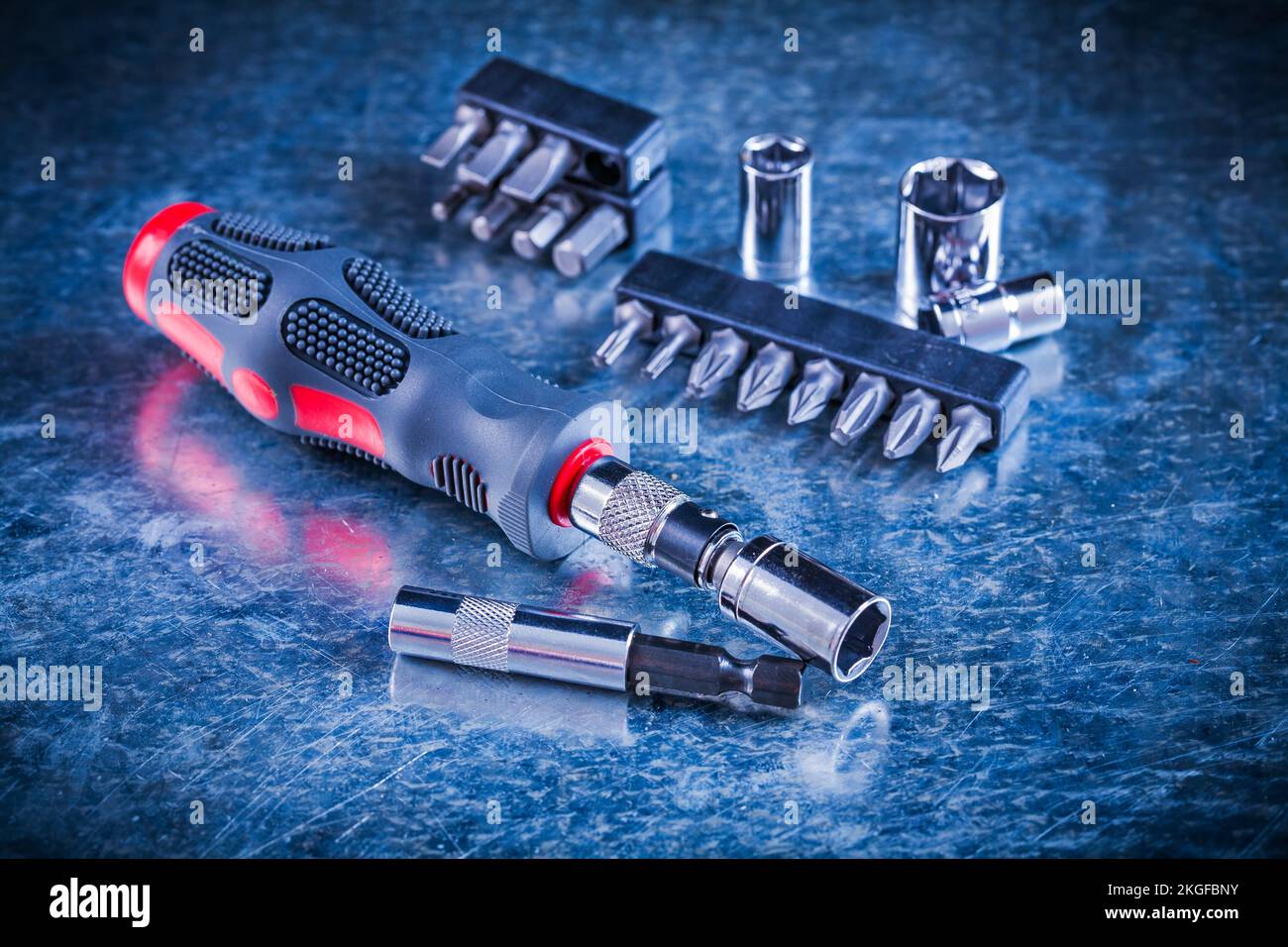 Turn screw with set of replaceable bits and torx on scratched metallic ...