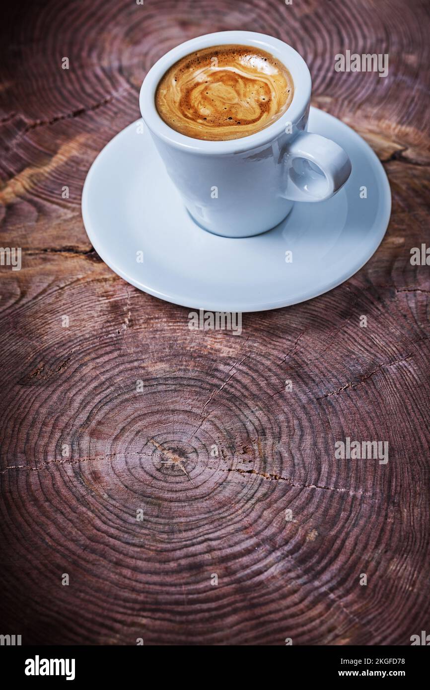 vertical view capuchino in white coffee cup on vintage wood cross ...
