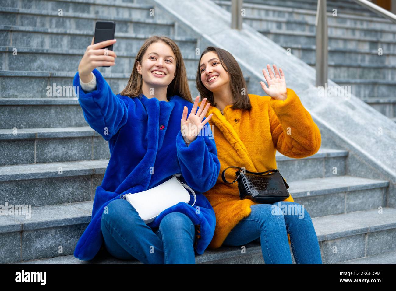 two generation z girls taking selfie, friends making video call outdoor ...