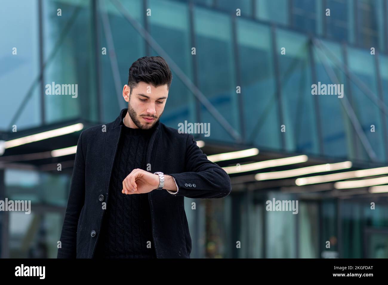 Young caucasian business man looking at his watch, business person ...