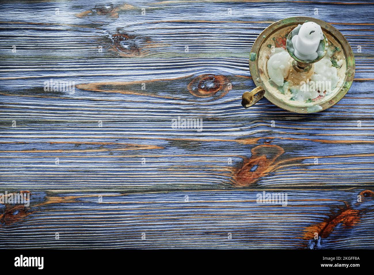 Vintage candleholder candle on blue wooden board Stock Photo - Alamy