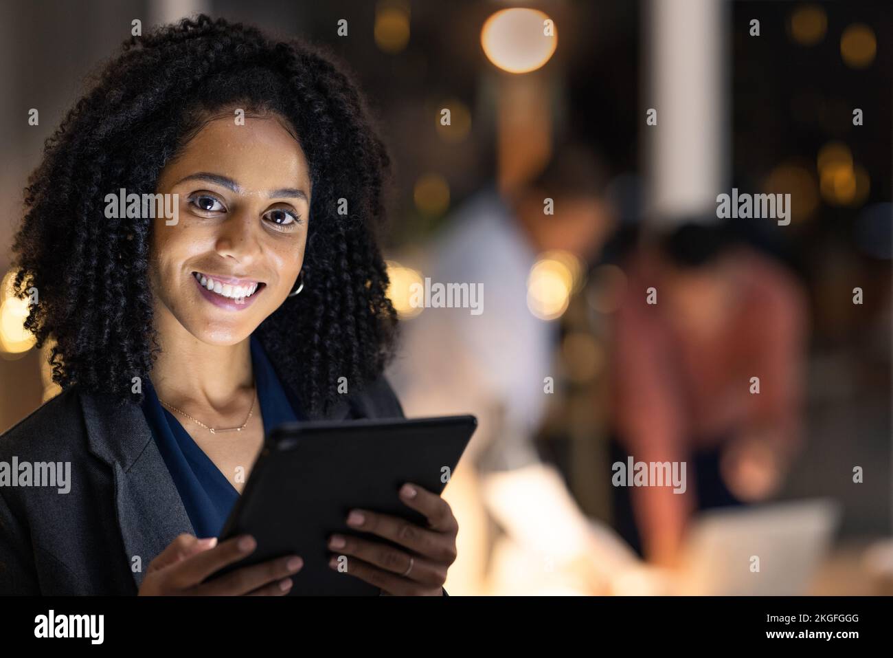 Face, tablet and night with a business black woman at work overtime ...