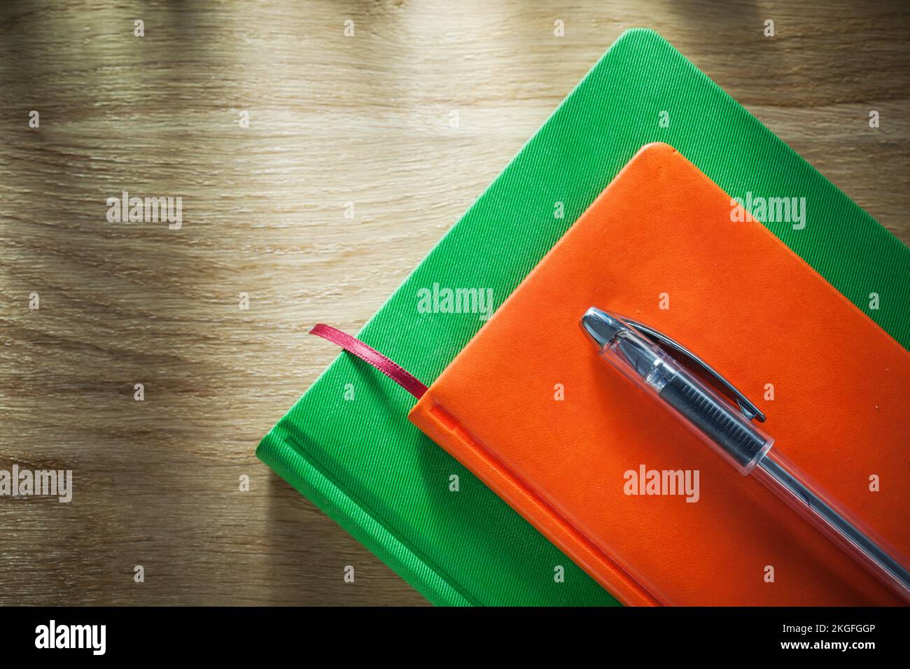 Vintage notebooks pen on wooden board education concept Stock Photo - Alamy