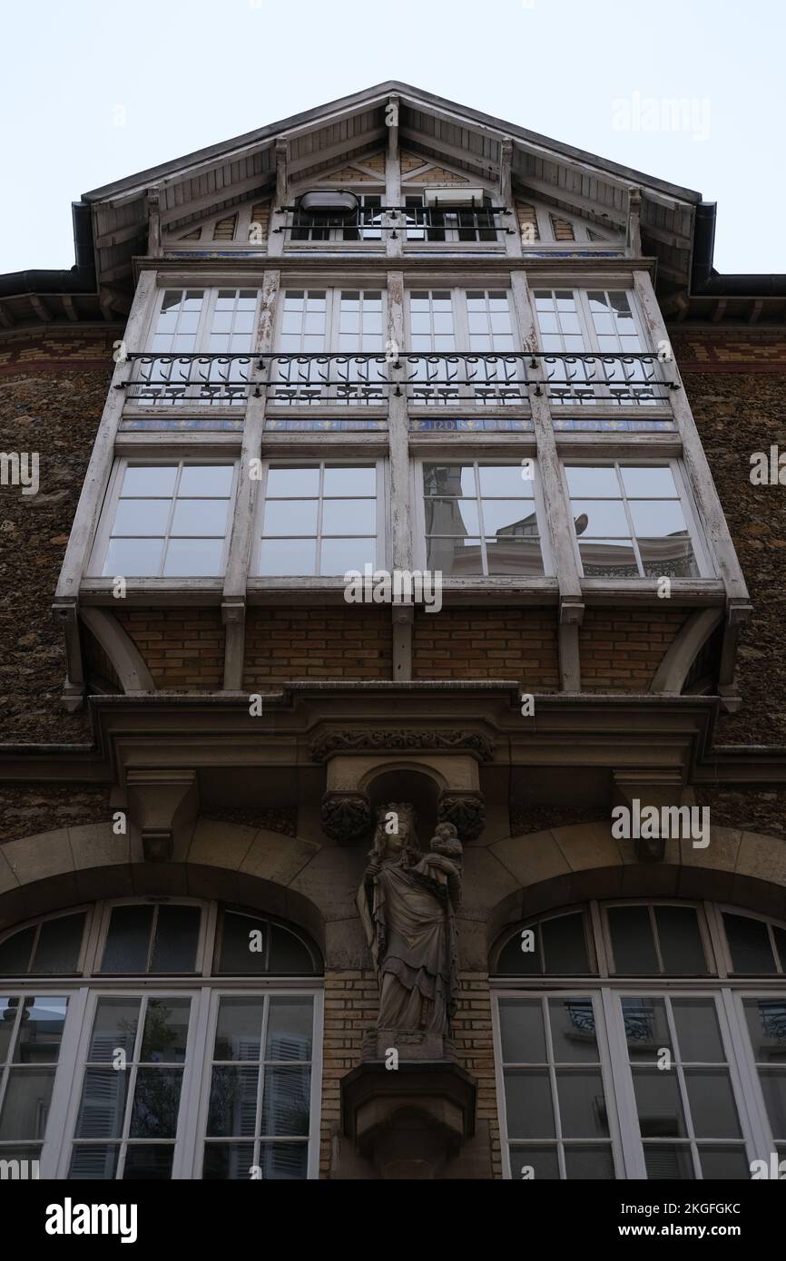 A vertical shot of an old landmark with glass windows and brick walls ...