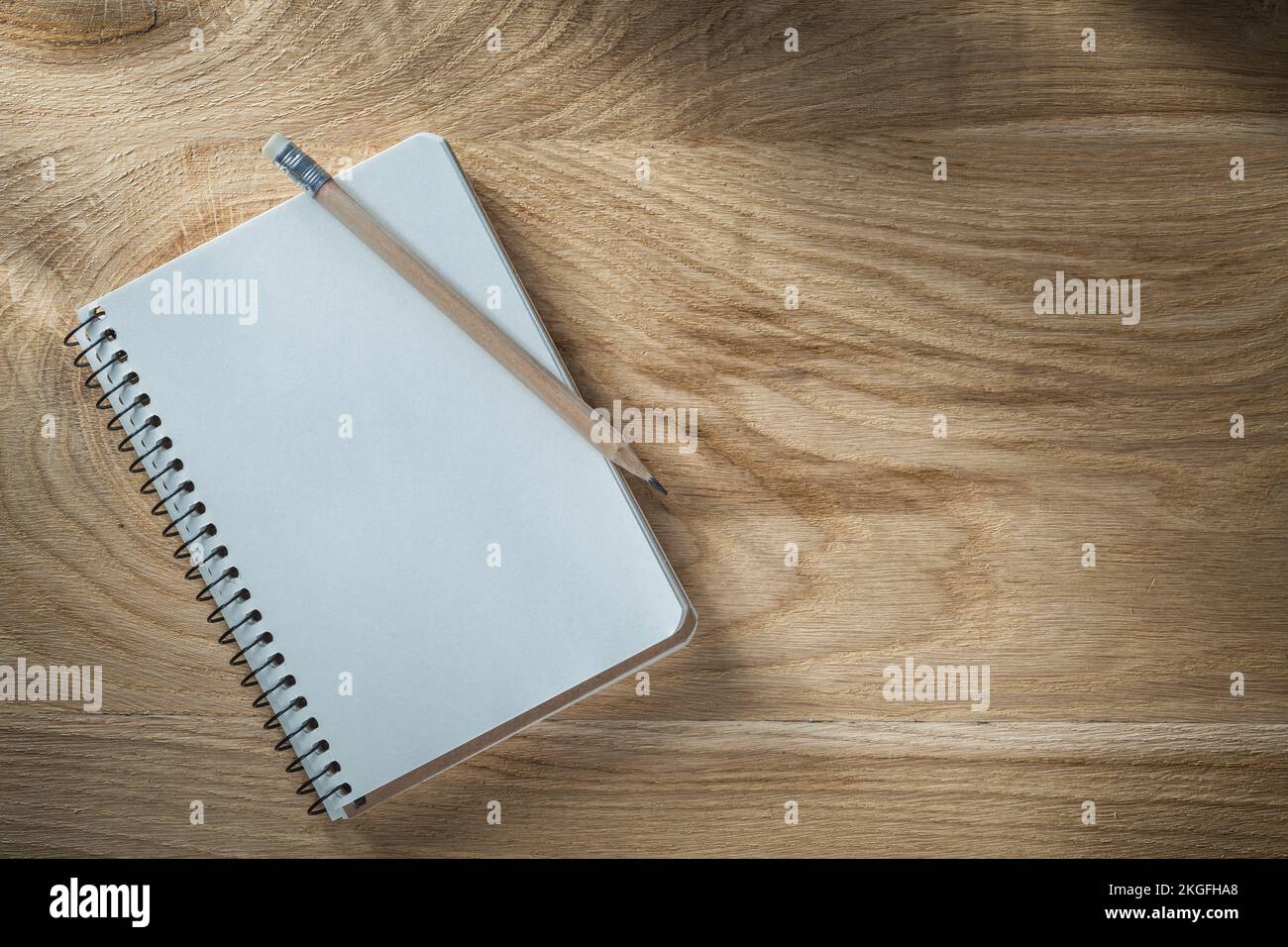 Vintage spiral notepad pencil on wooden board top view Stock Photo - Alamy