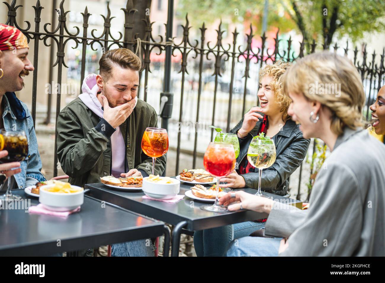 Lgbt group of diverse people sitting at restaurant having fun, happy ...