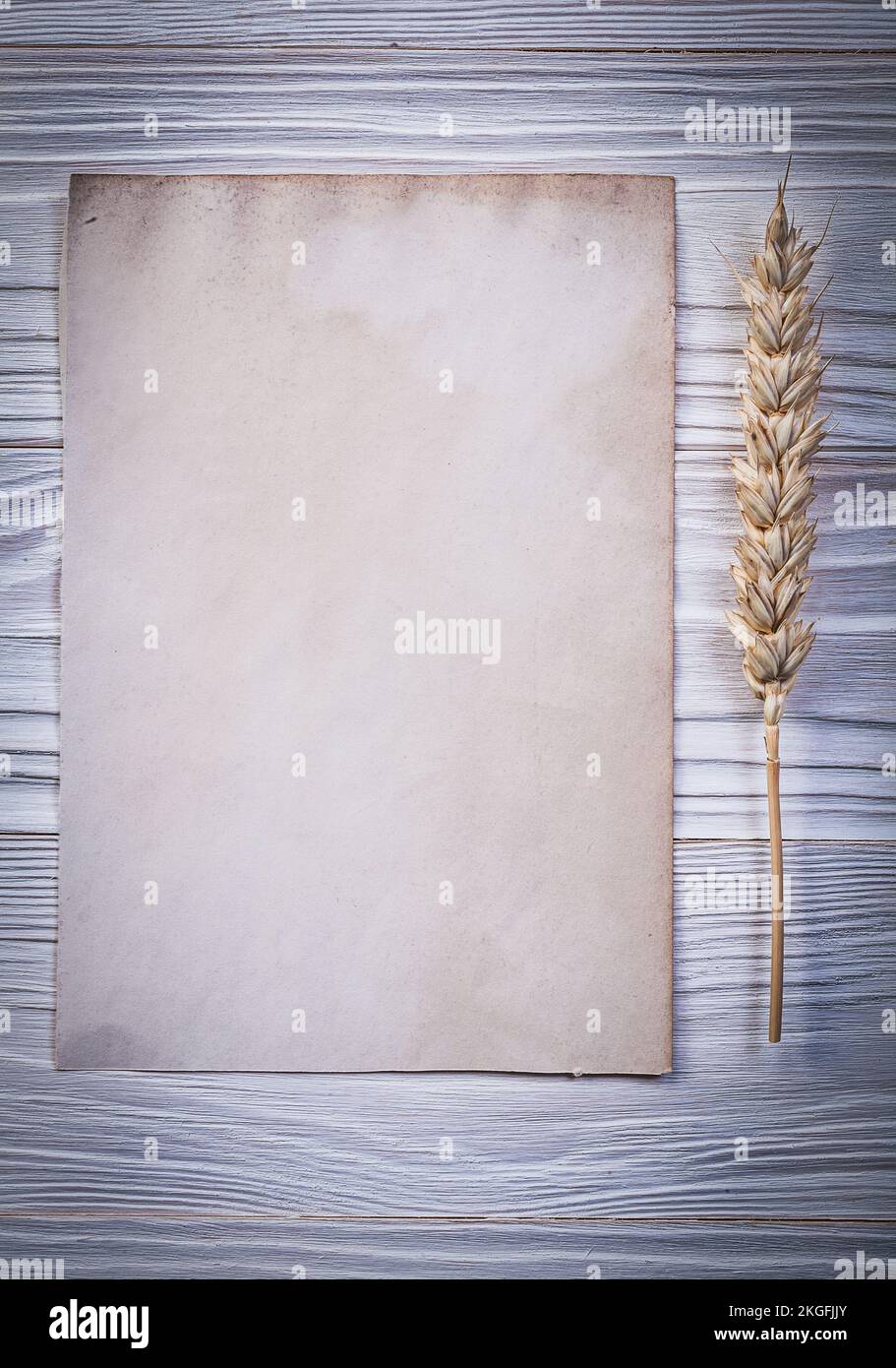Wheat ear blank vintage paper sheet on wooden board directly above ...