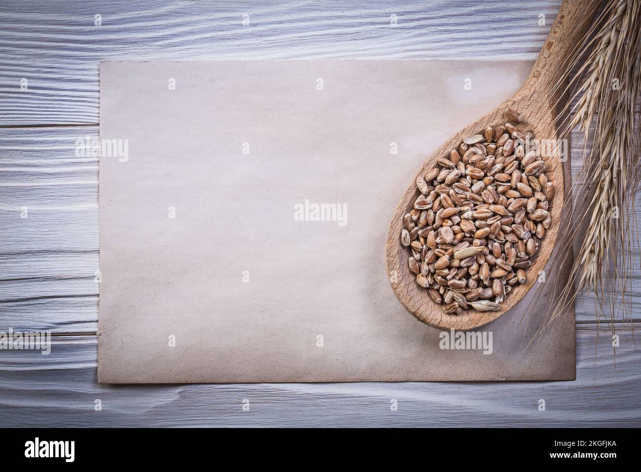 Wheat rye ears grain wooden spoon vintage paper on wood board food and ...