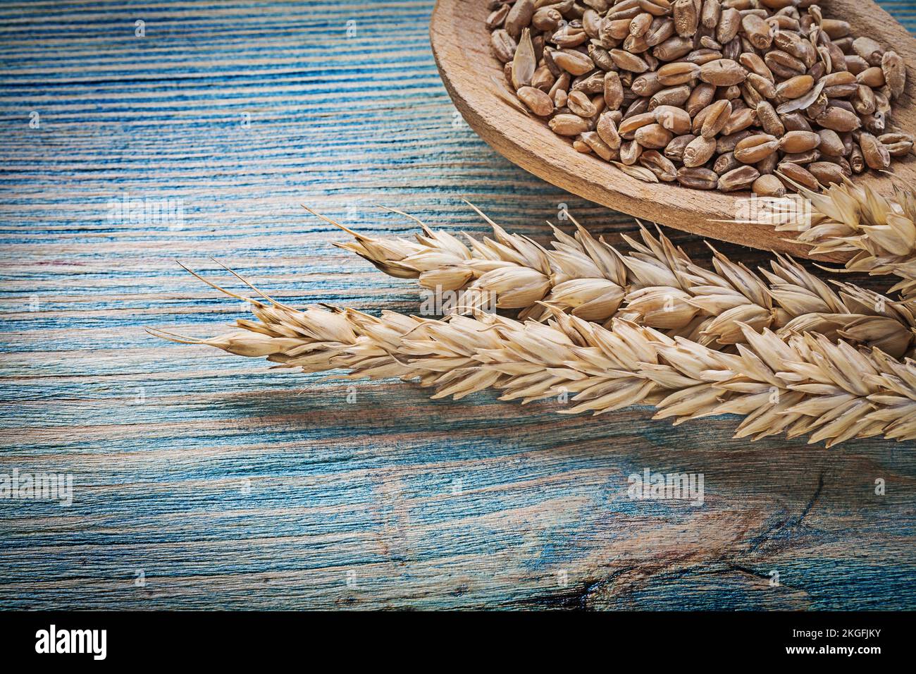Wheat rye ears grains wooden spoon on wood board Stock Photo - Alamy