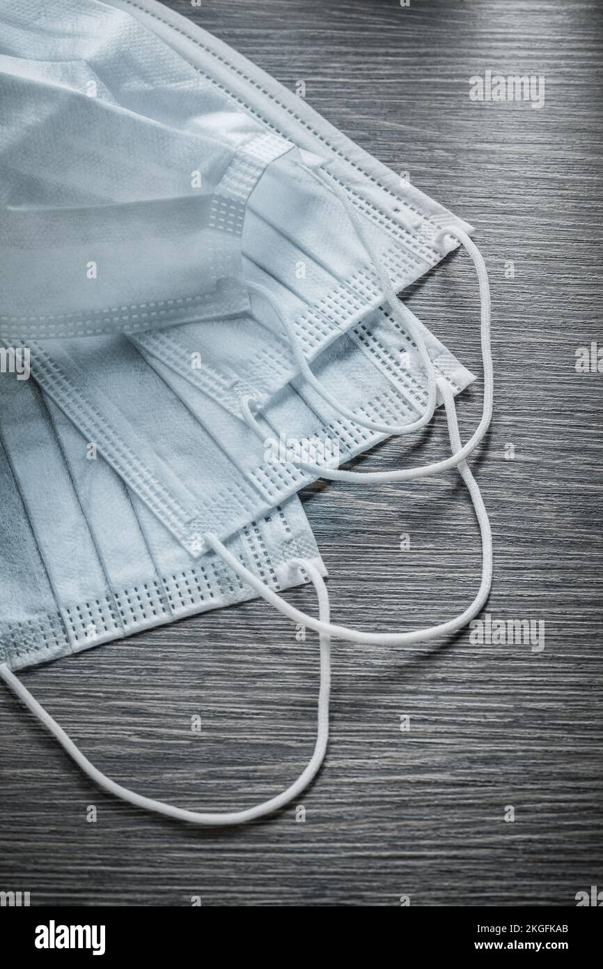 White protective surgical masks on vintage wooden board Stock Photo - Alamy