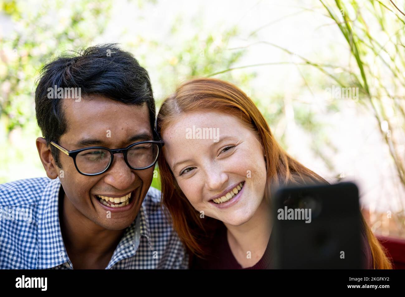 selfie with a young couple of lovers, red head woman and north african ...