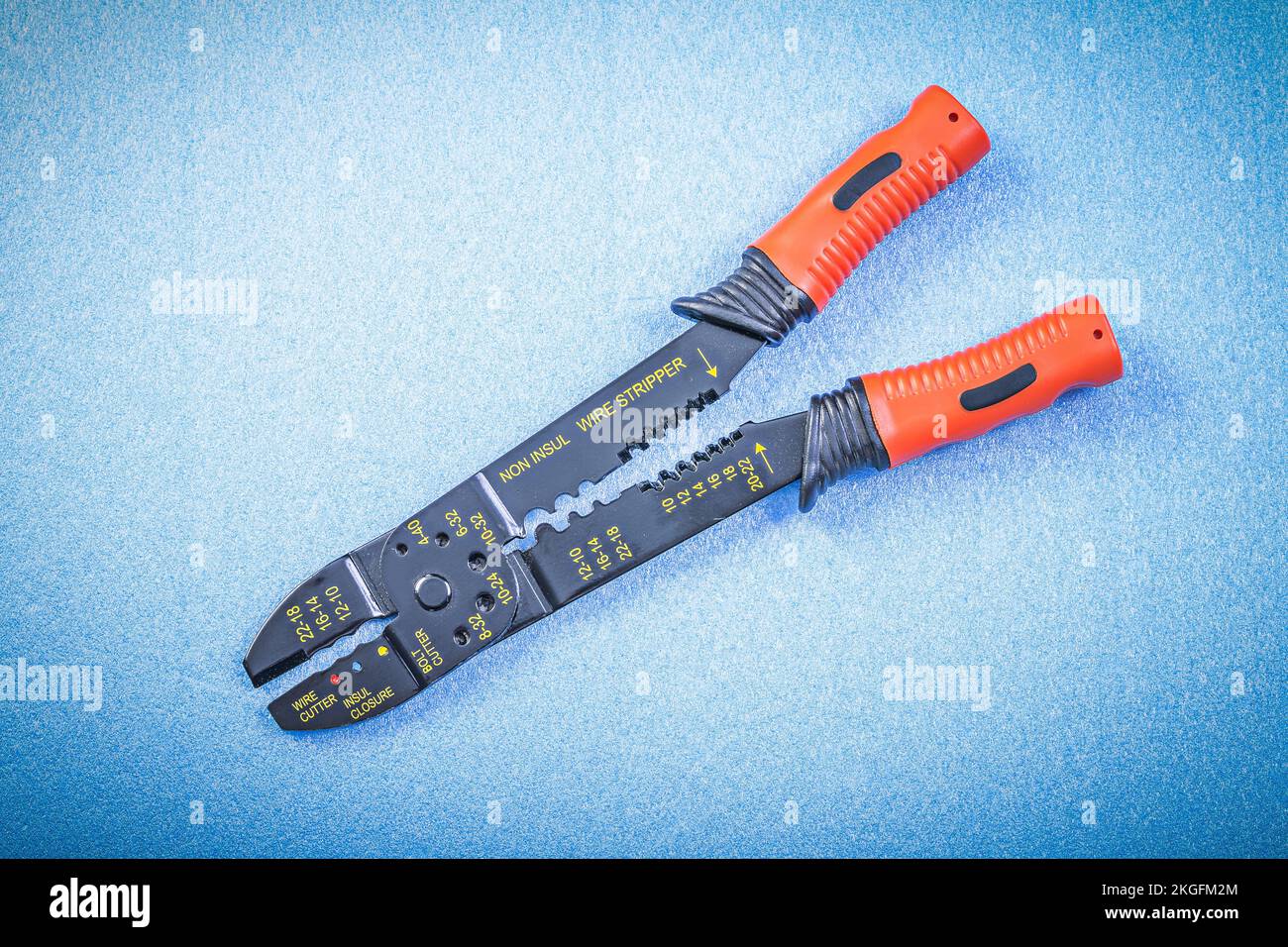 Wire stripper on blue surface directly above electricity concept Stock ...