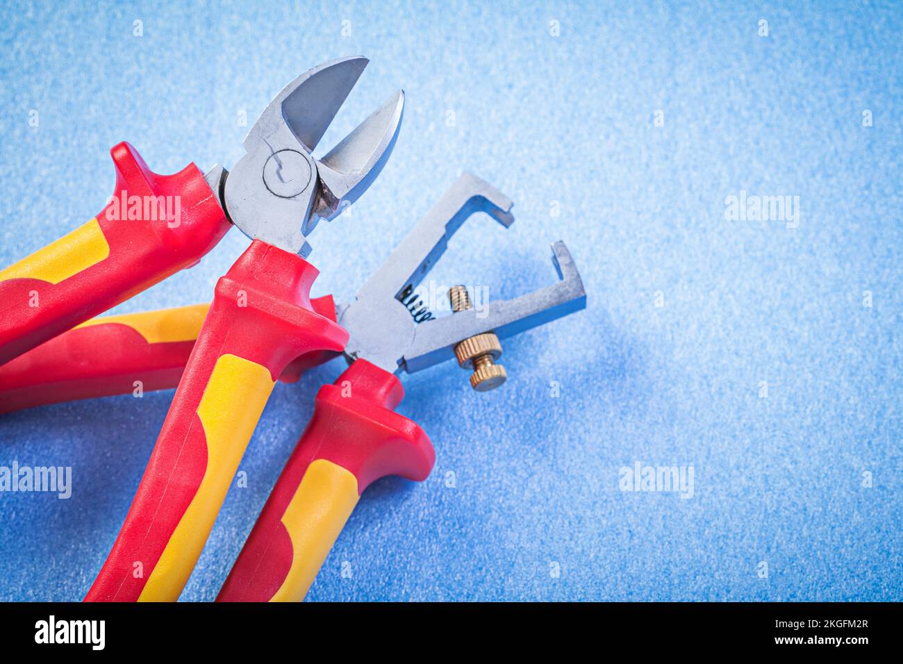 Wire stripper cutting pliers on blue background electricity concept ...