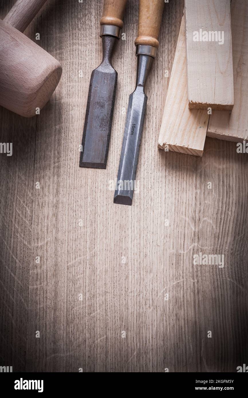 Wooden bricks hammer carpenter’s firmer chisels on wood background ...