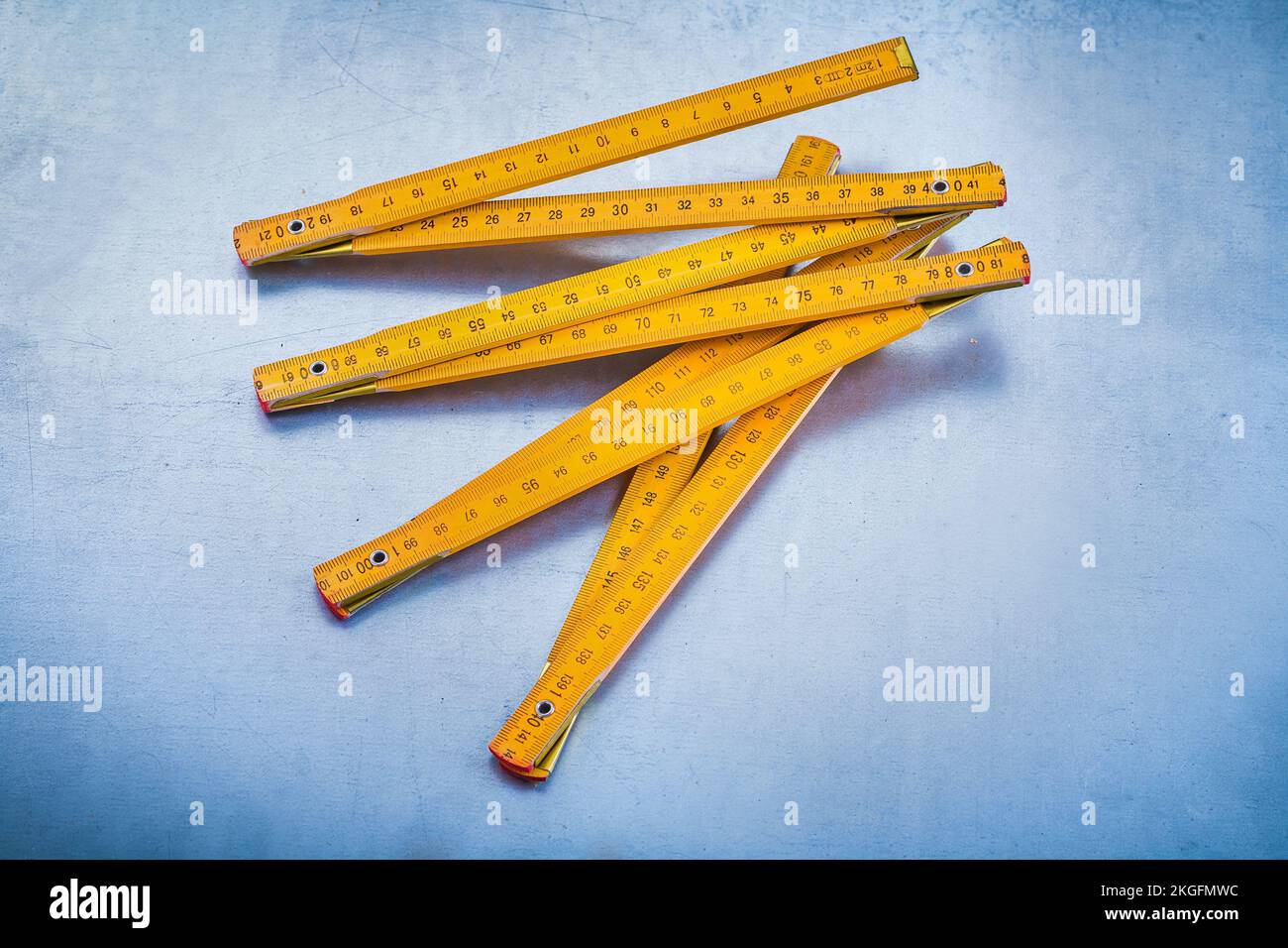 Wooden meter on metallic background vertical view construction concept ...